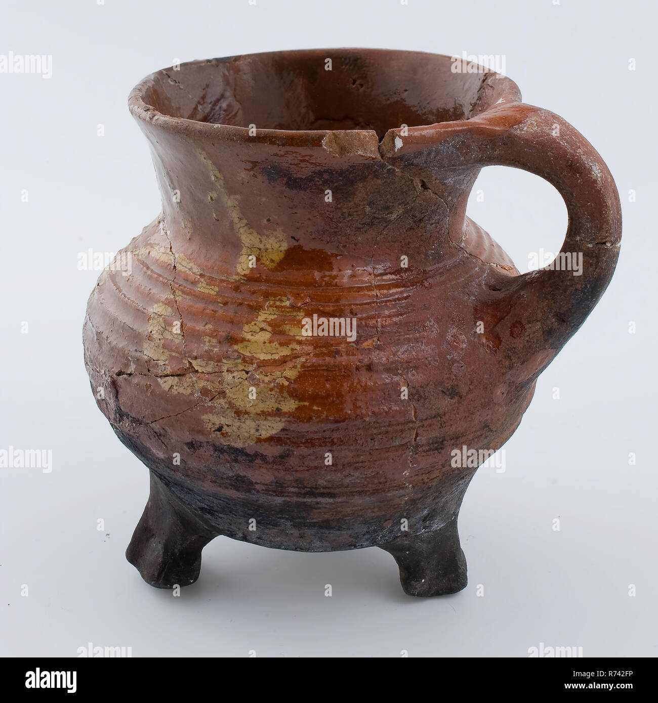 Pottery cooking jug on three legs, sludge decoration on the shoulder ...