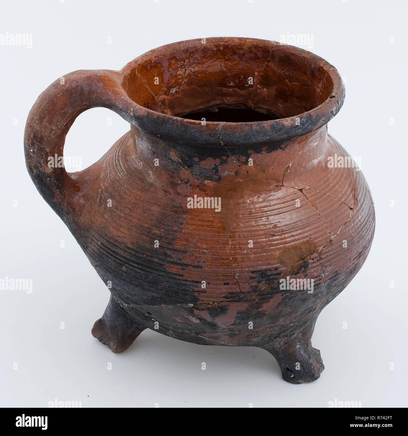 Pottery cooker on three legs, rings on the shoulder and pinched sausage ...