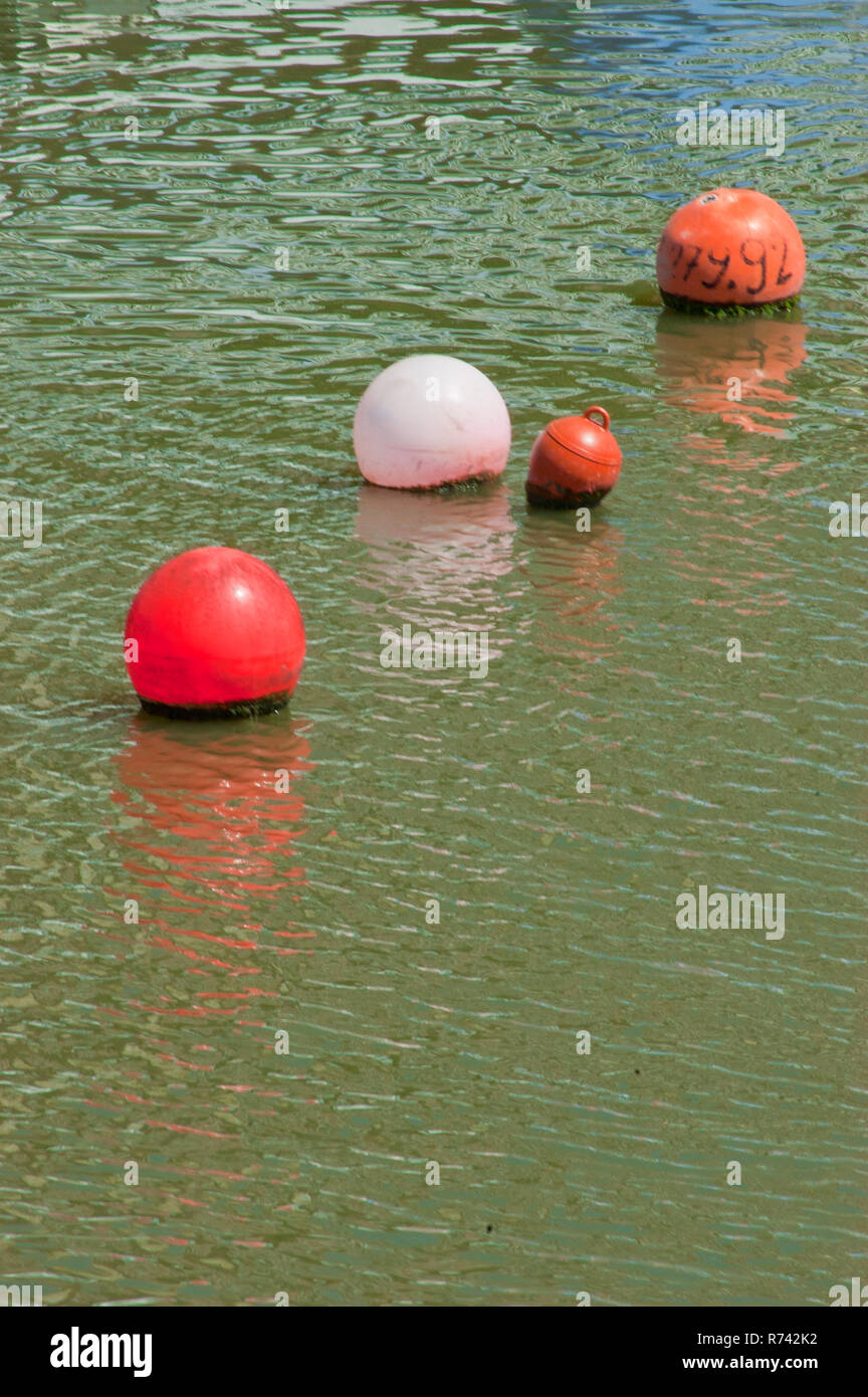 Four buoys floating in the water in the marina, Valencia, Spain Stock ...