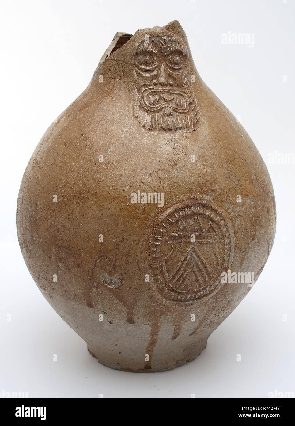 Light brown Bartmann jug, also called Bellarmine jug, under mask oval ...