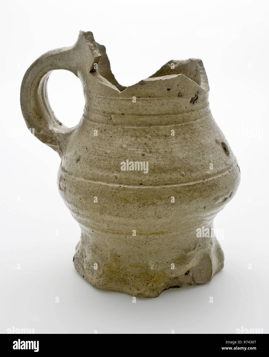 Stoneware jug with ear, pinched foot, glazed, double conical belly ...
