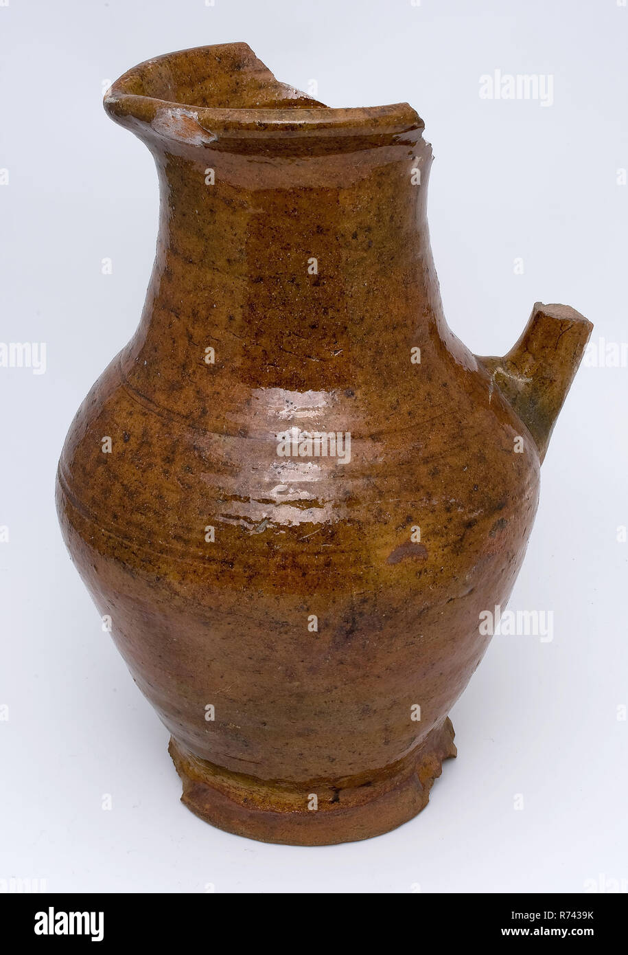 Pottery jug be glazed on stand, with an ear, shaving clip, and twisted ...