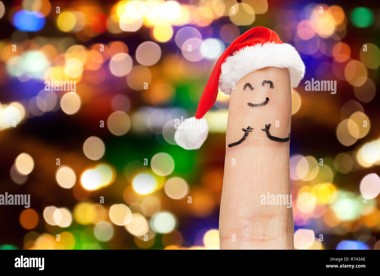 close up of finger in santa hat over lights Stock Photo - Alamy