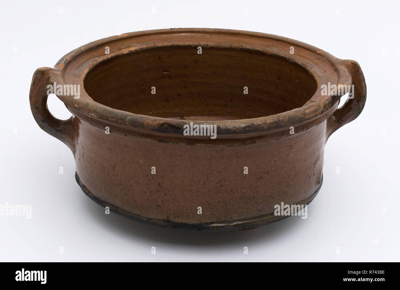 Pottery cooking pot on three legs, cylindrical in shape with two band ...