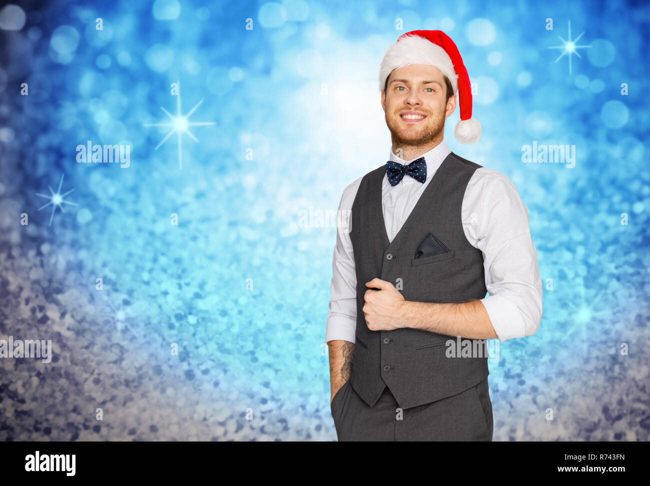 happy man in santa hat and suit on christmas Stock Photo - Alamy