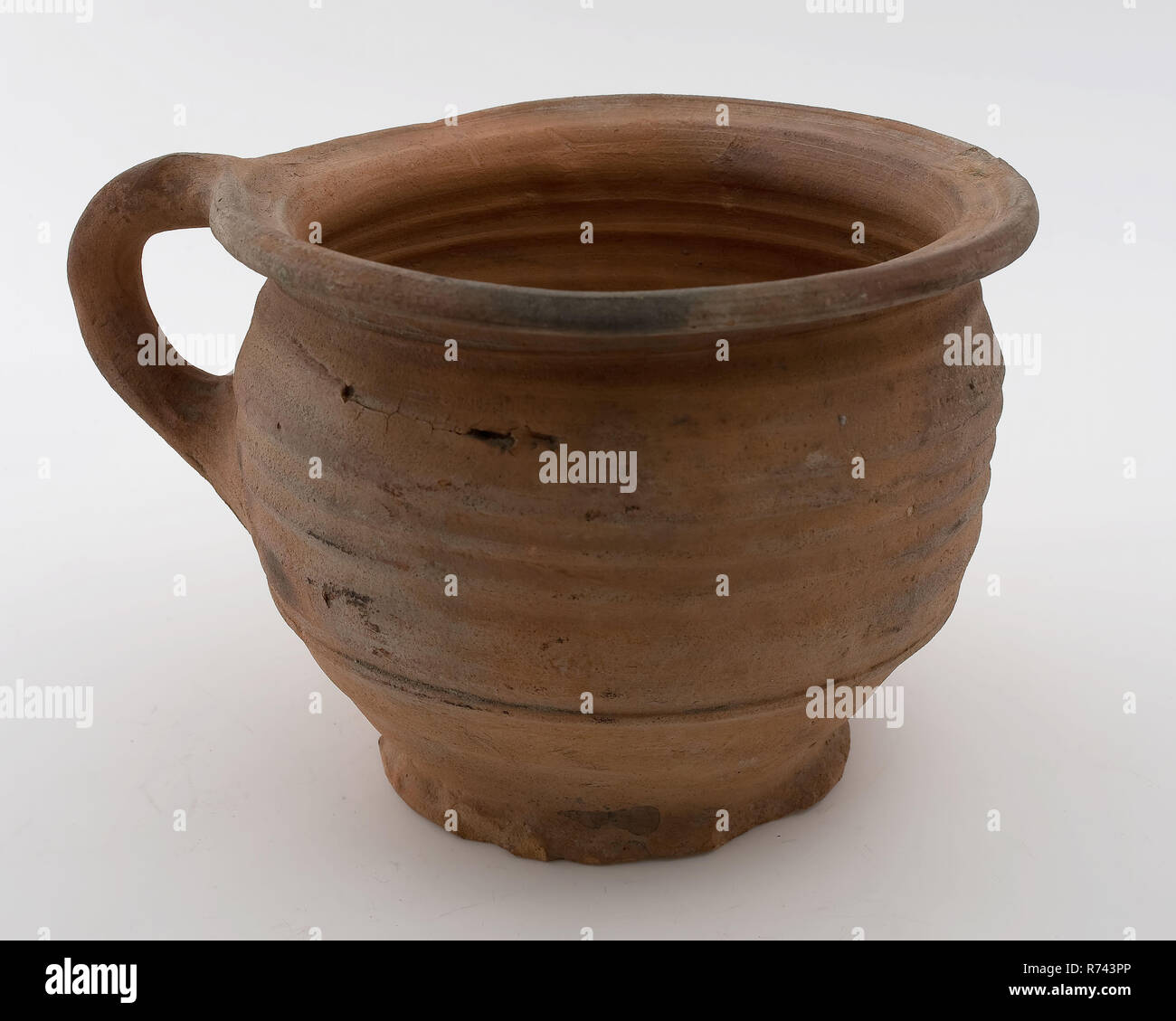 Pottery flower pot, orange shard, unglazed, sausage ear, on stand ...