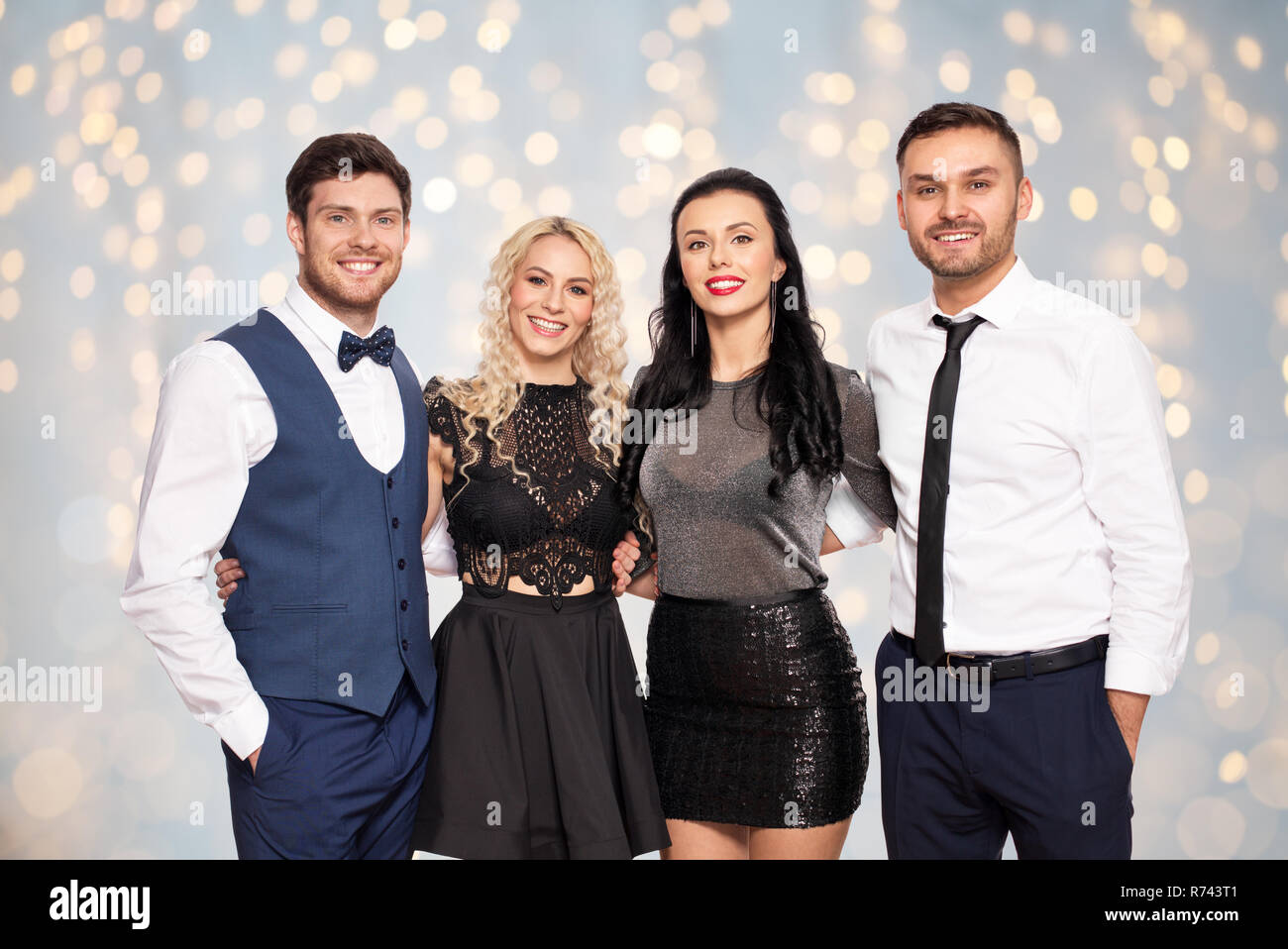 happy friends in party clothes hugging Stock Photo - Alamy
