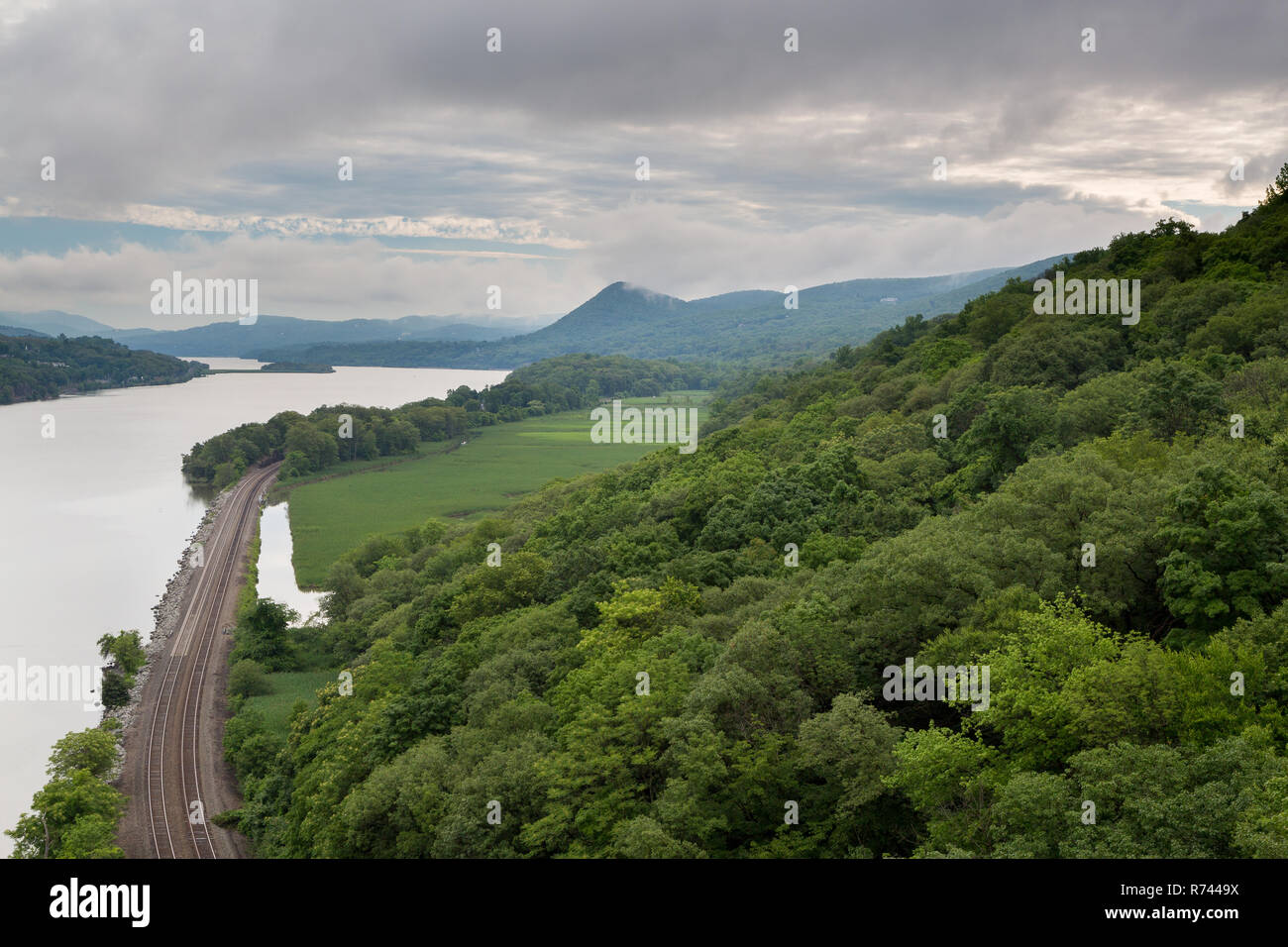 The Hudson Highlands rising above the Hudson River and the railroad ...
