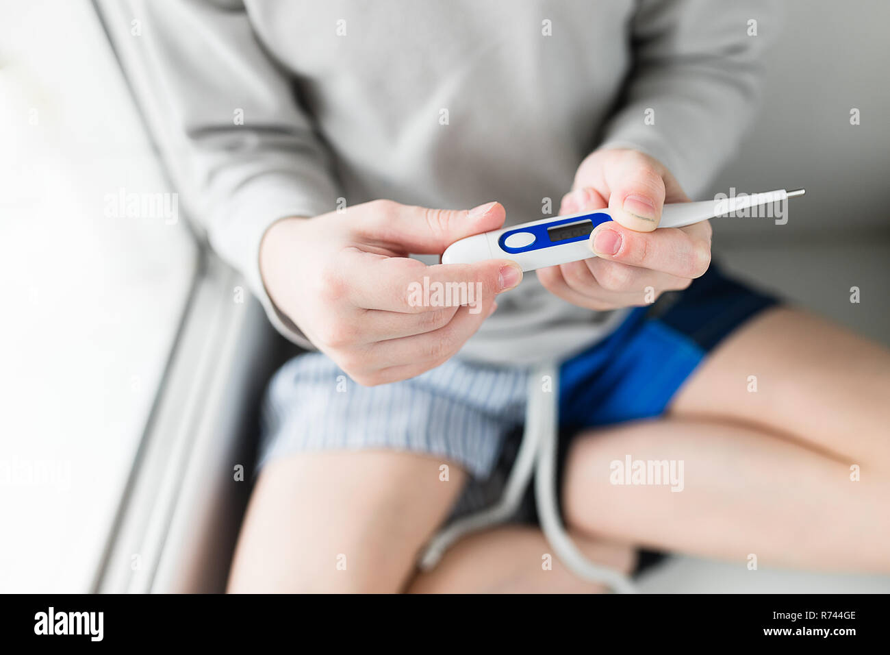 Child boy thermometer measures temperature. High temperature on the ...