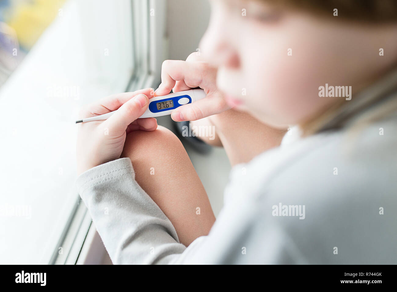 Child boy thermometer measures temperature. High temperature on the ...