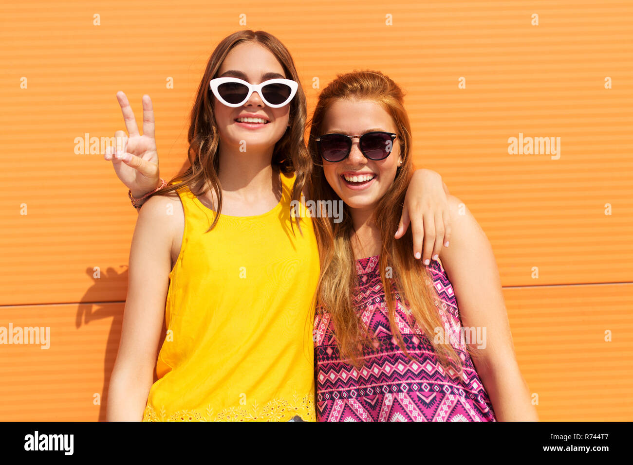 smiling teenage girls showing peace in summer Stock Photo - Alamy