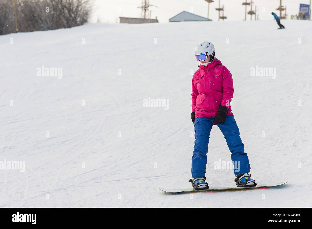 Woman snowboarder on the slopes frosty winter day. Beautiful girl on ...