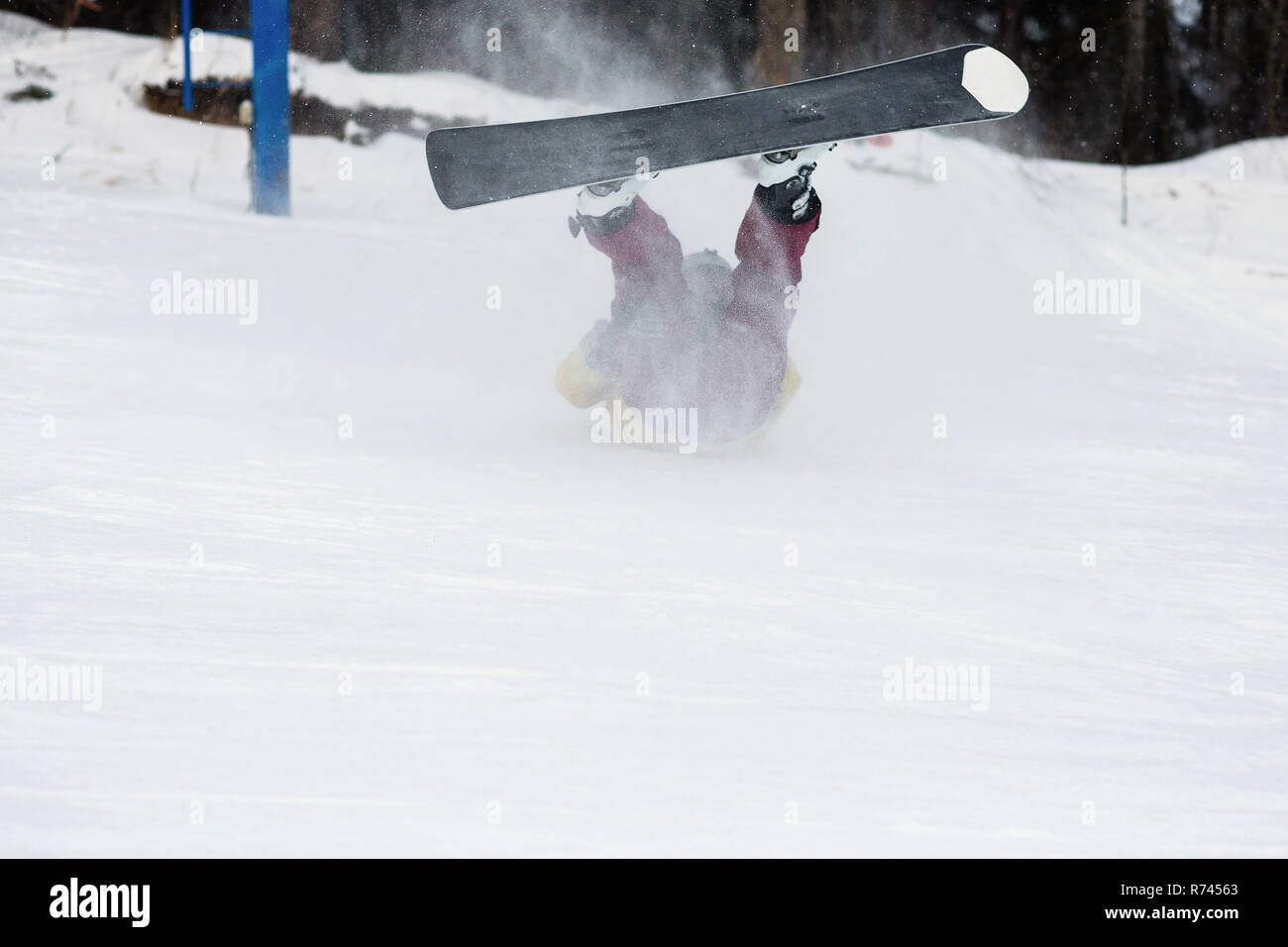 Male snowboarder falls on the slopes during the descent Stock Photo - Alamy