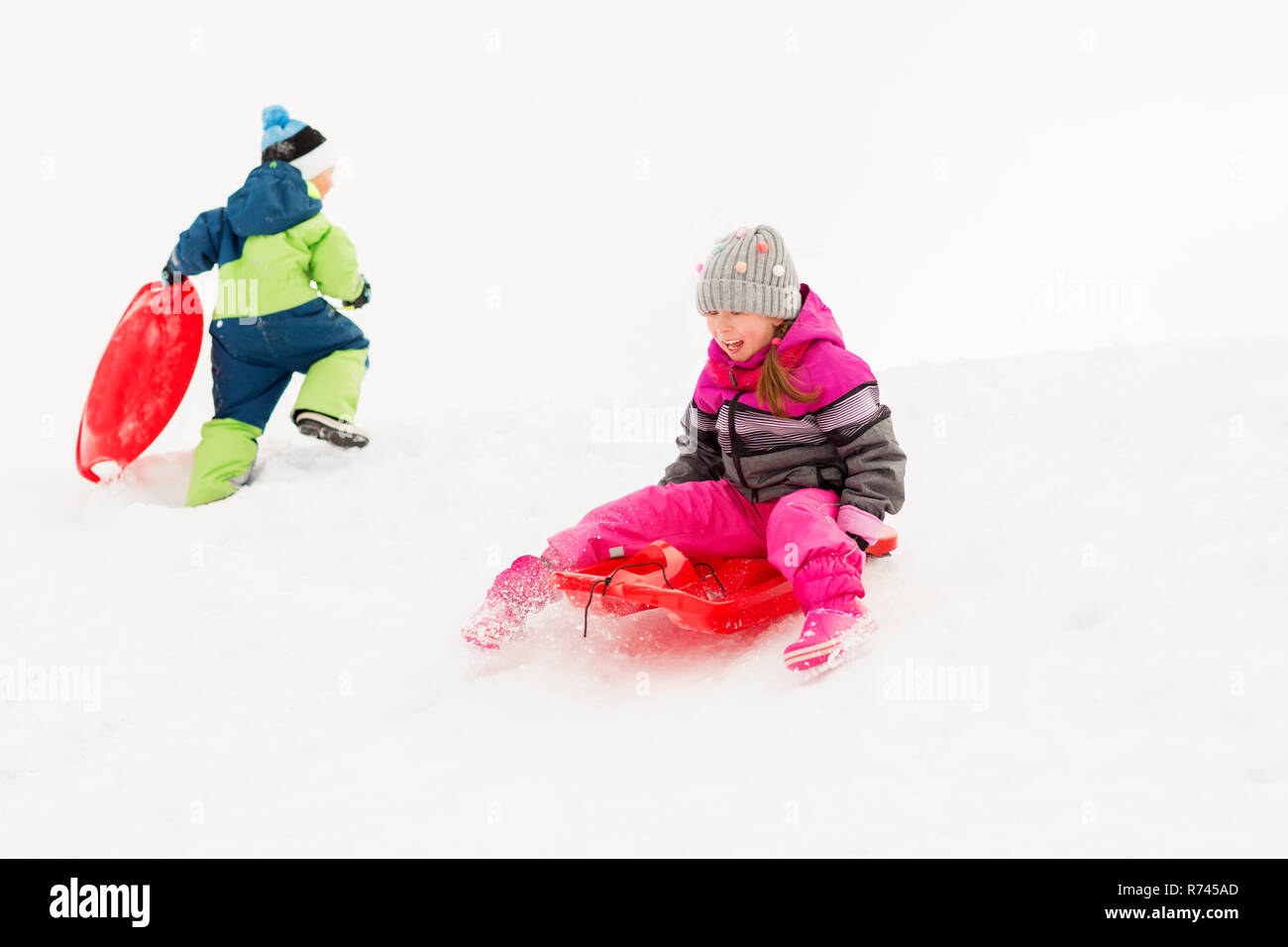 Child girl people person riding sledge sliding snow hi-res stock ...