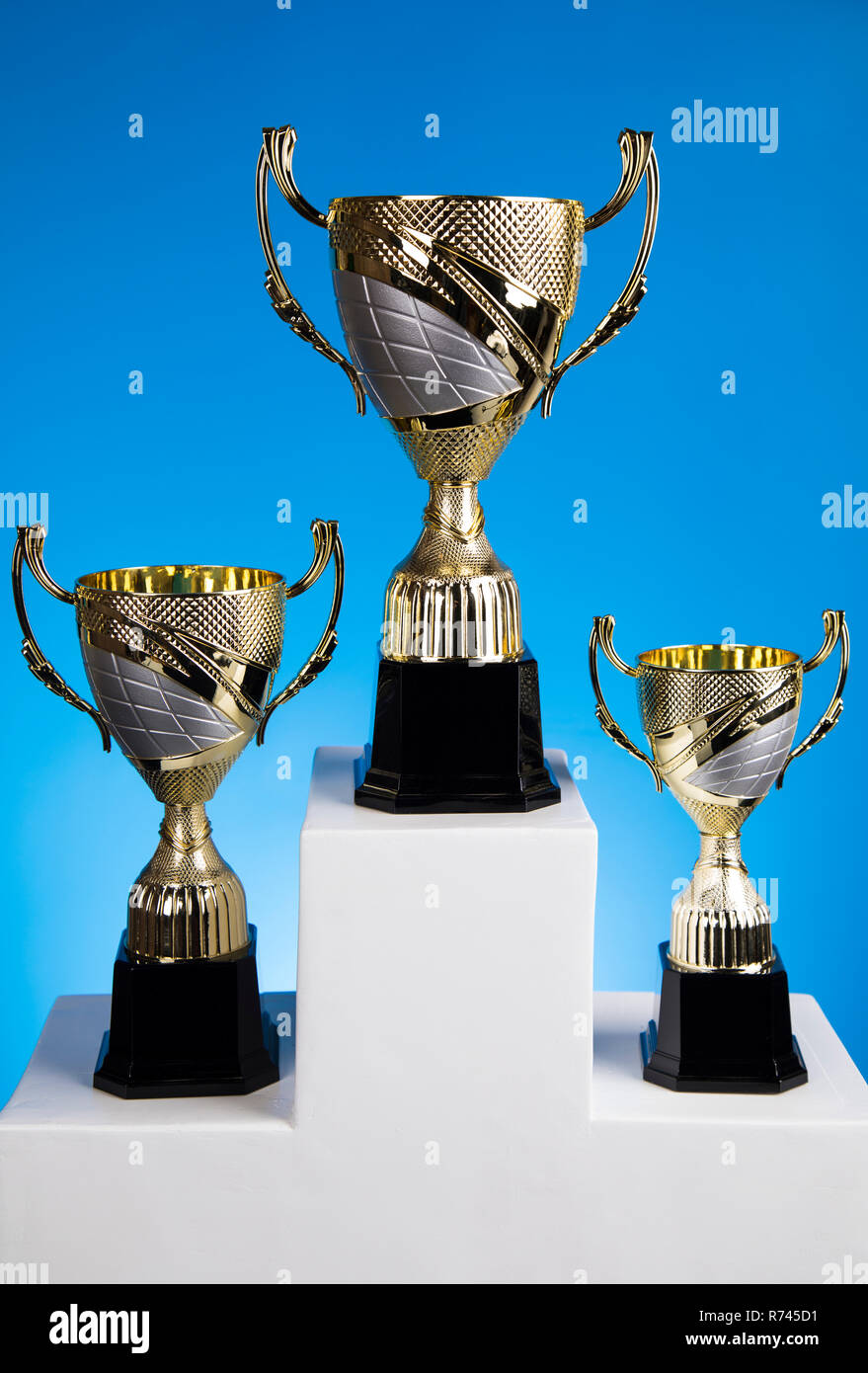 Sport podium, Cups of winners award Stock Photo - Alamy