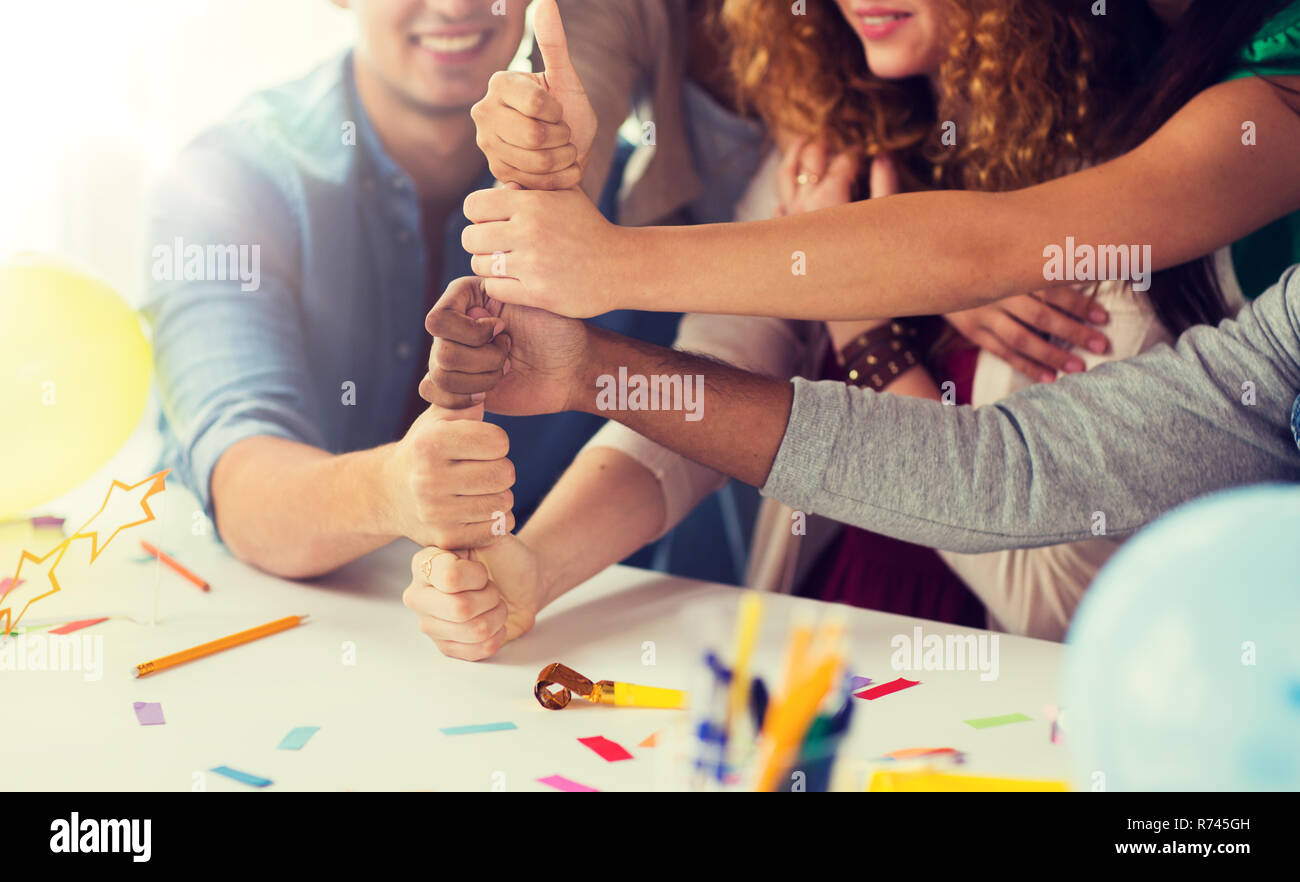 team making thumbs up hand sign at office party Stock Photo - Alamy
