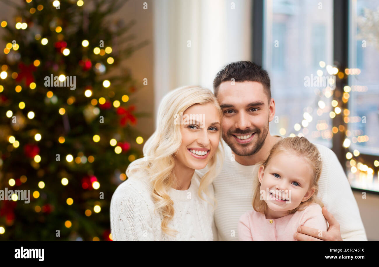 happy family at home over christmas tree lights Stock Photo - Alamy