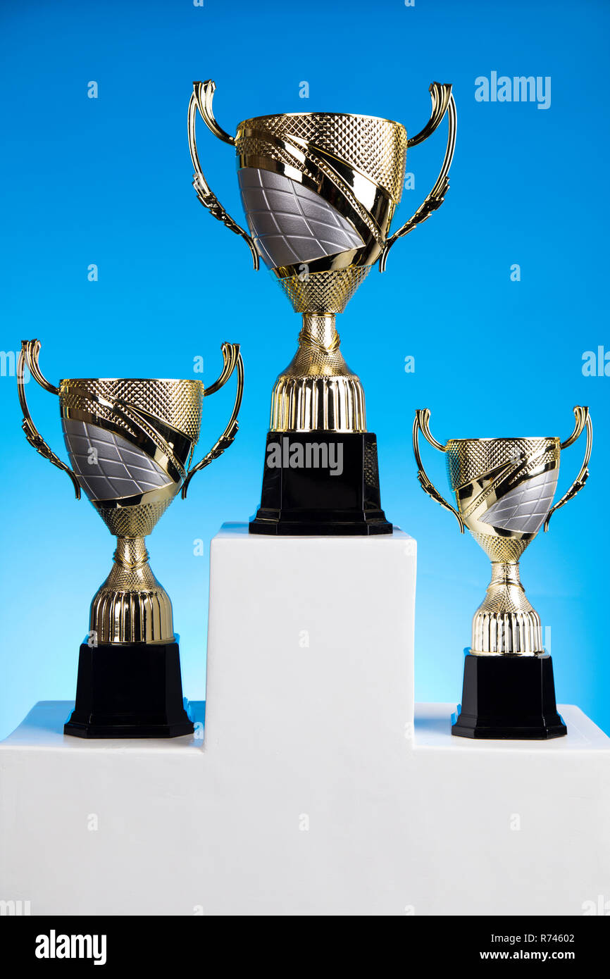 Sport podium, Cups of winners award Stock Photo - Alamy