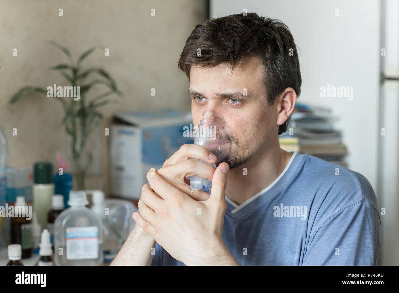 Portrait Of Young Man Inhaling Through Inhaler Mask Stock Photo - Alamy