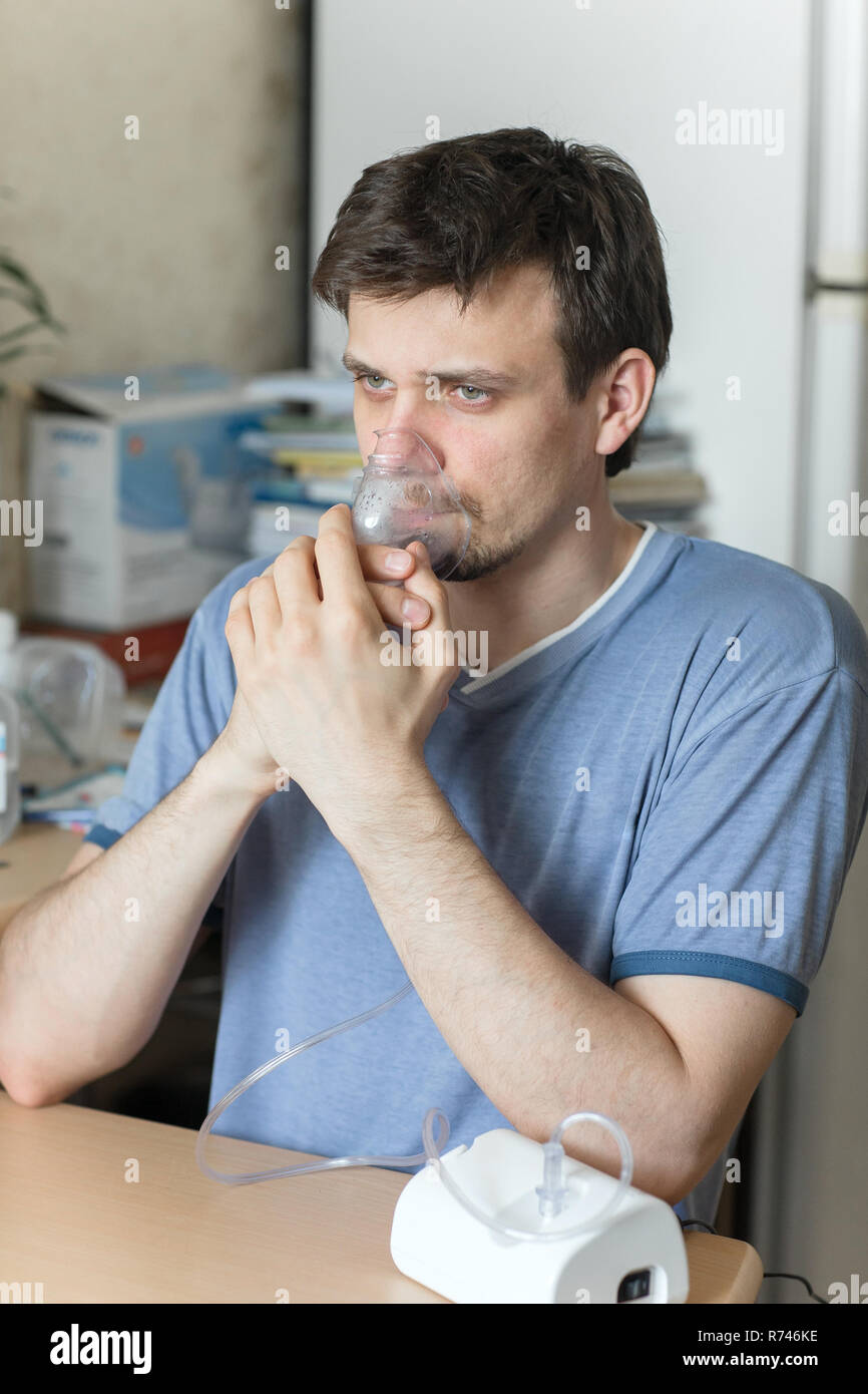 Portrait Of Young Man Inhaling Through Inhaler Mask Stock Photo - Alamy