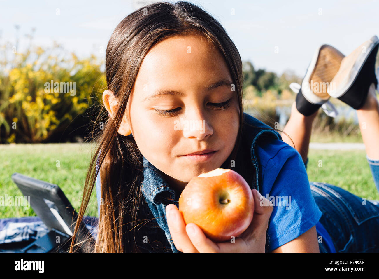 Girl enjoying apple, Long Beach, California, US Stock Photo - Alamy
