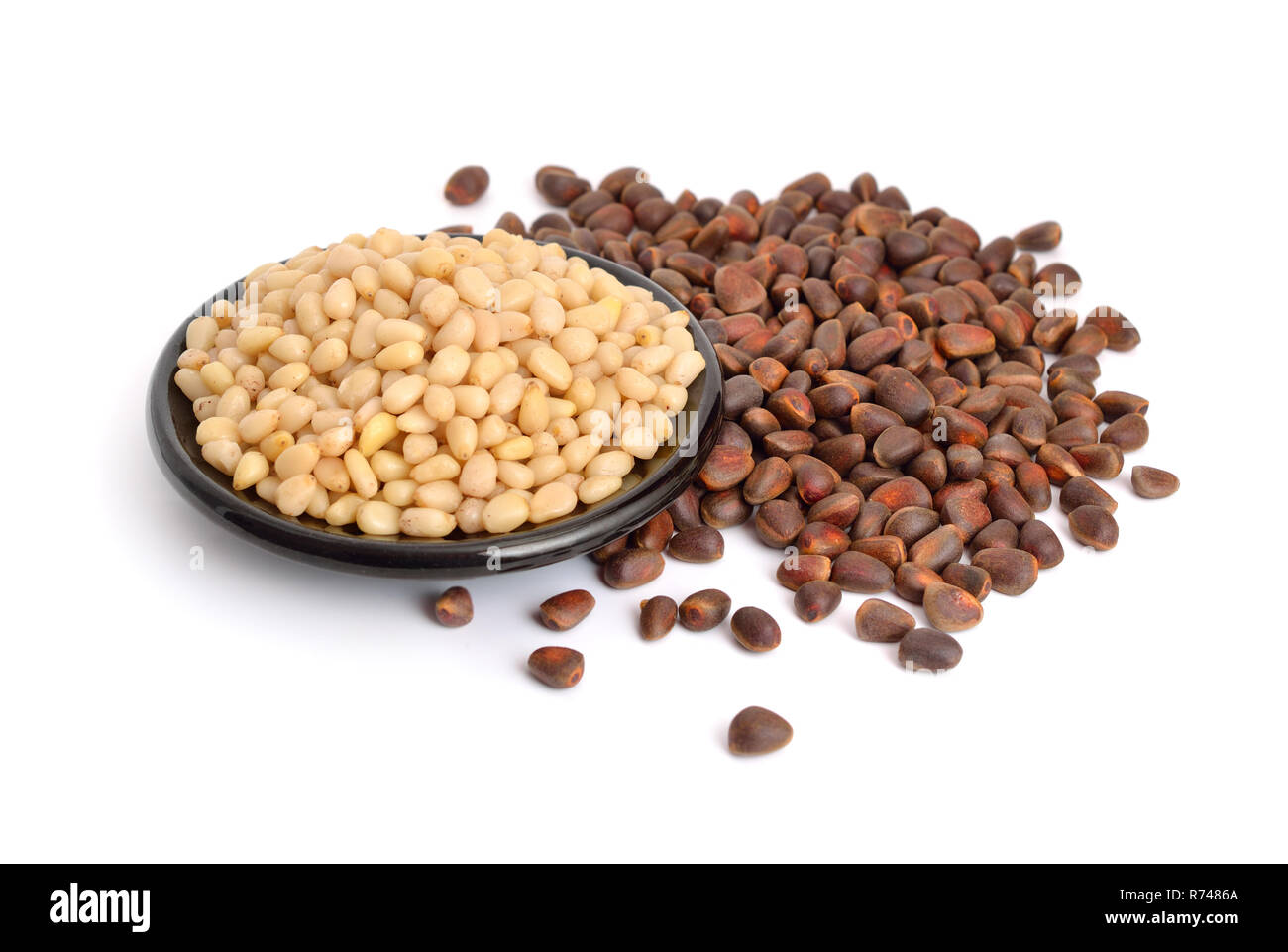 Shelled pine nuts. Isolated on white background Stock Photo - Alamy