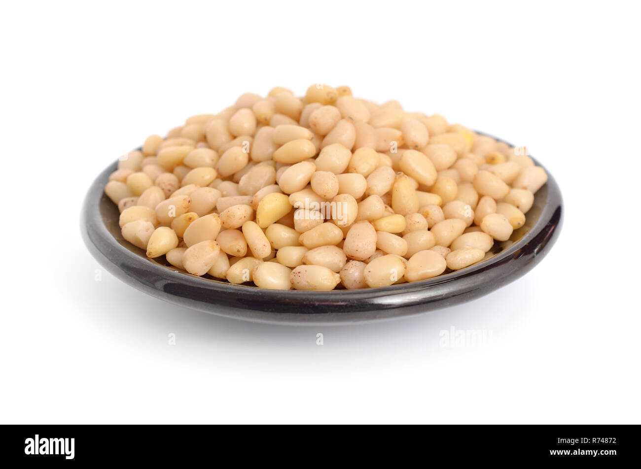 Shelled pine nuts. Isolated on white background Stock Photo - Alamy