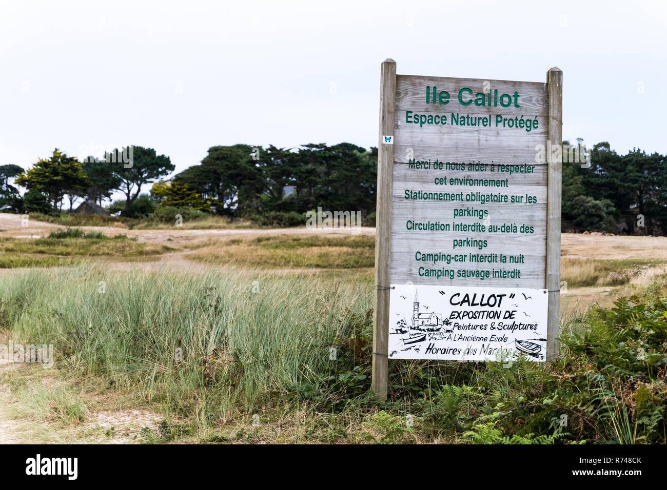 Carantec, France. Signs at the entrance of Ile Callot, a tidal island ...
