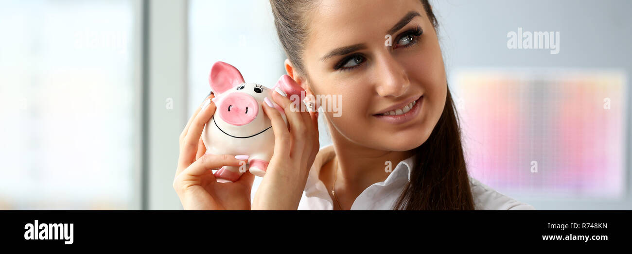 Happy beautiful woman shake in arms funny piggybank Stock Photo - Alamy