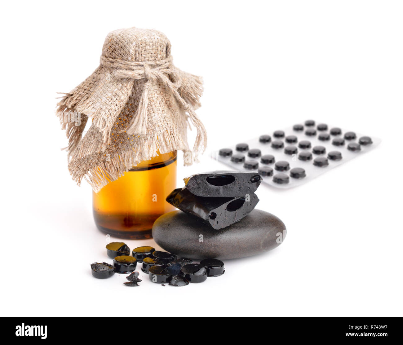 Shilajit, Mumijo. Tablets and solution isolated on white background ...