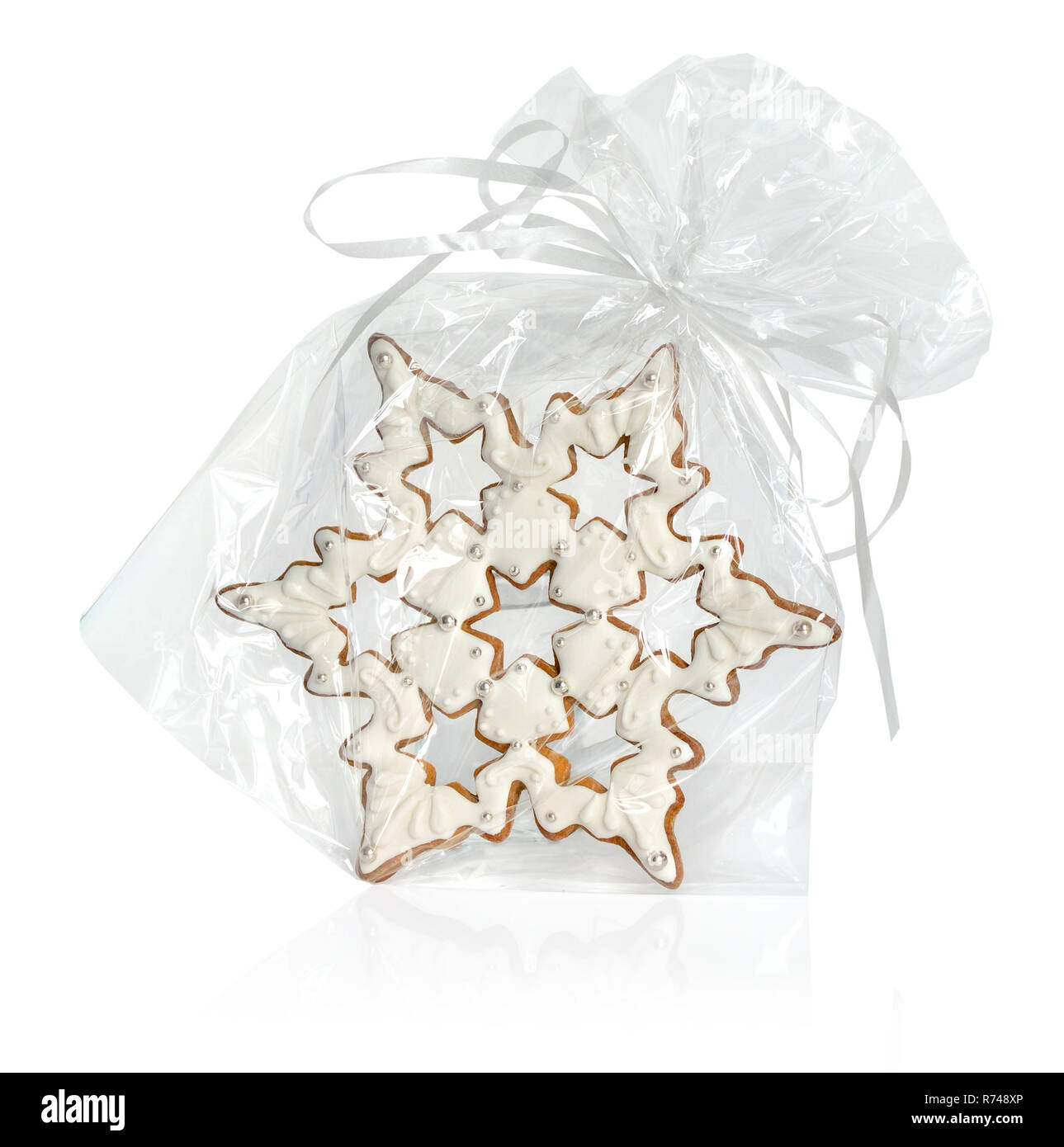 Snowflake gingerbread in transparent packing with a bow. Isolated Stock ...