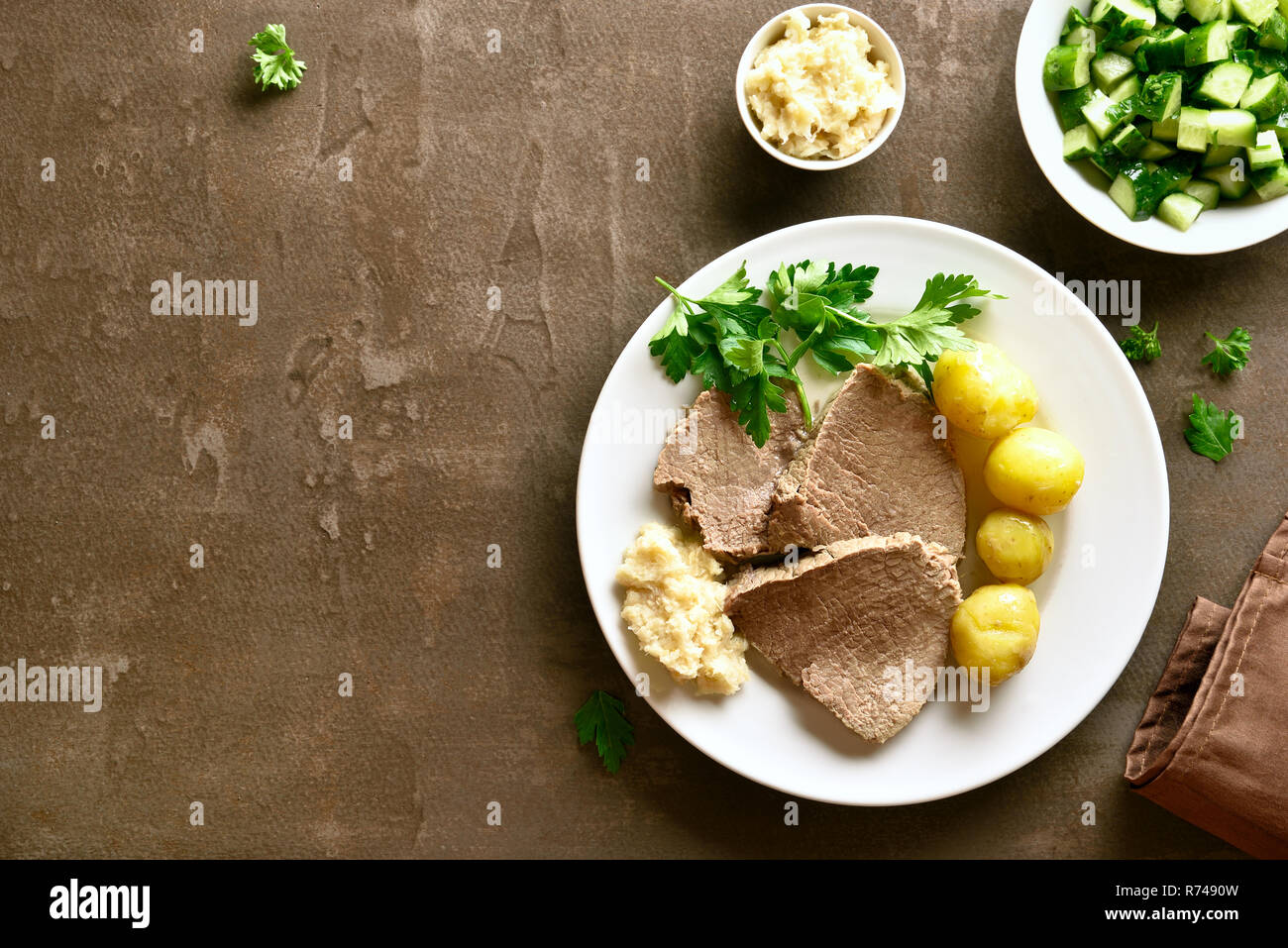 Tafelspitz, boiled beef with potatoes and horseradish on brown ...