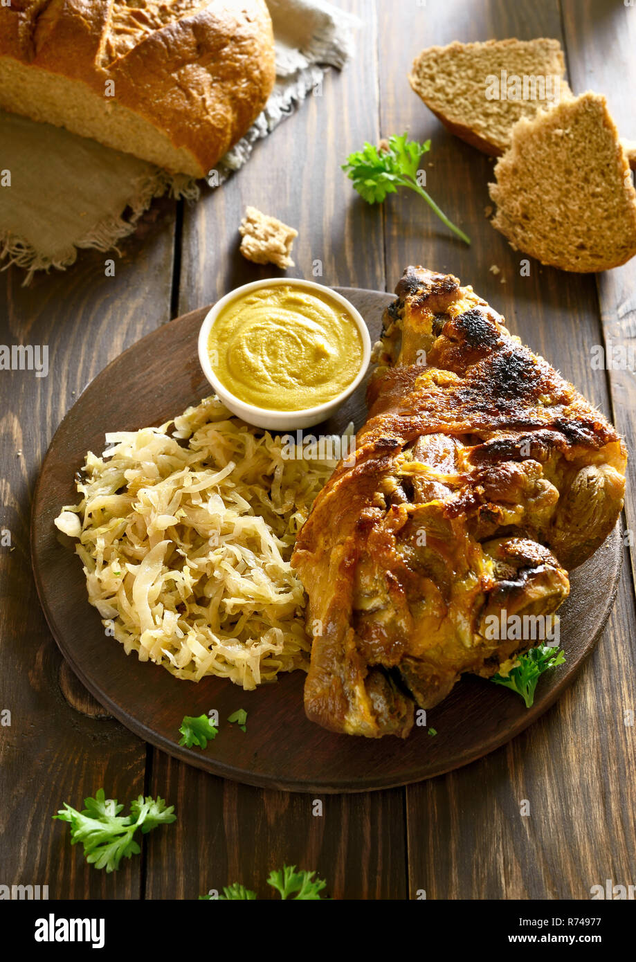 Roasted pork knuckle (eisbein) with braised cabbage (sauerkraut) and ...