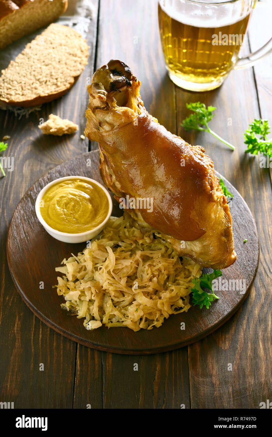 Roasted pork knuckle (eisbein) with braised cabbage (sauerkraut) and ...