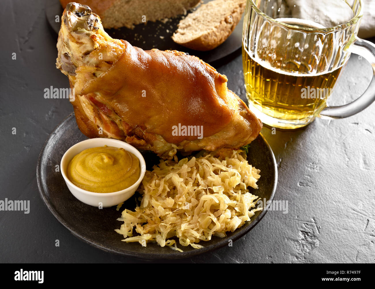 Pork knuckle (eisbein) with braised cabbage (sauerkraut) and beer on ...