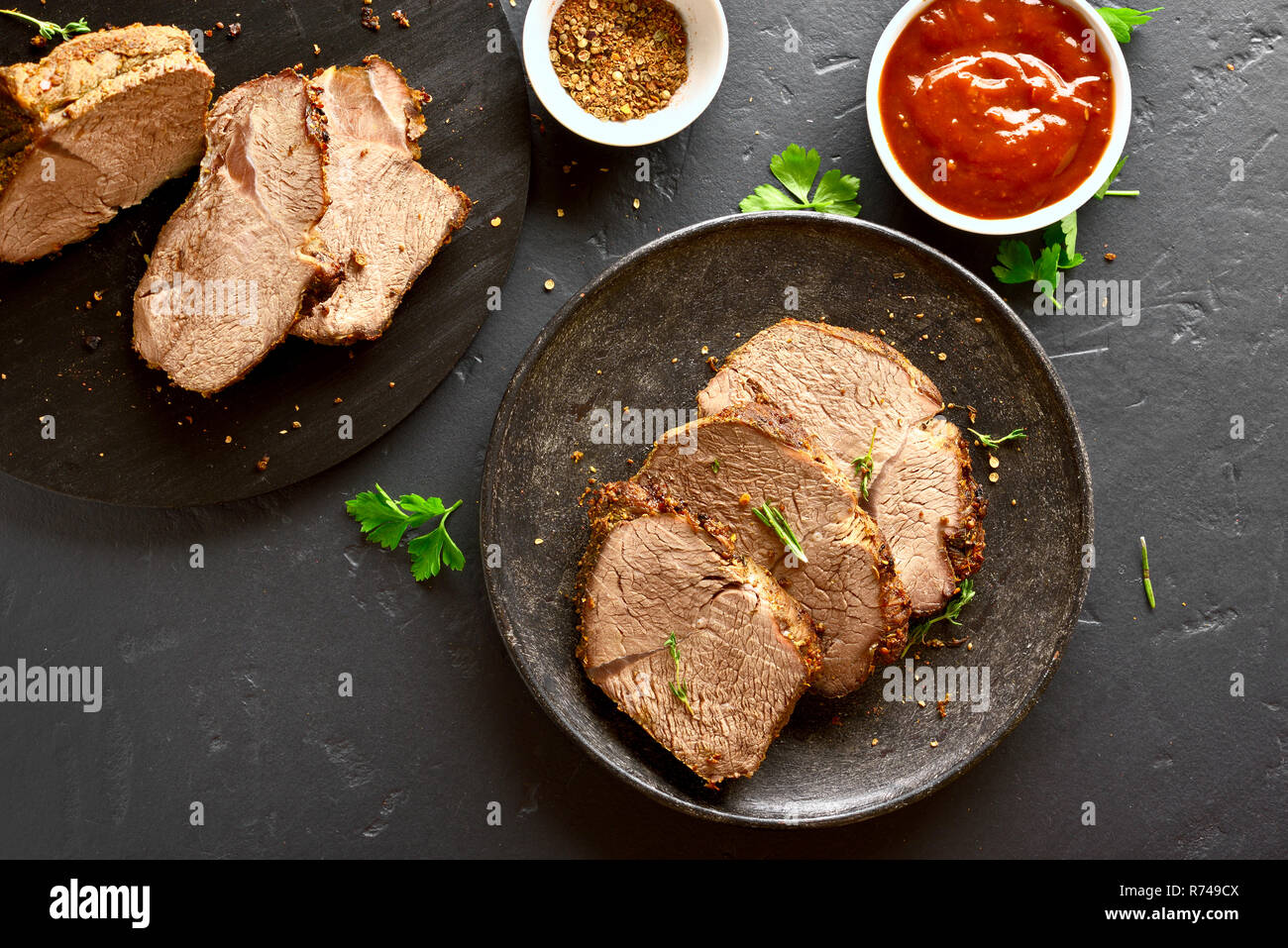 Grilled roast beef on plate over stone backround. Top view,flat lay ...