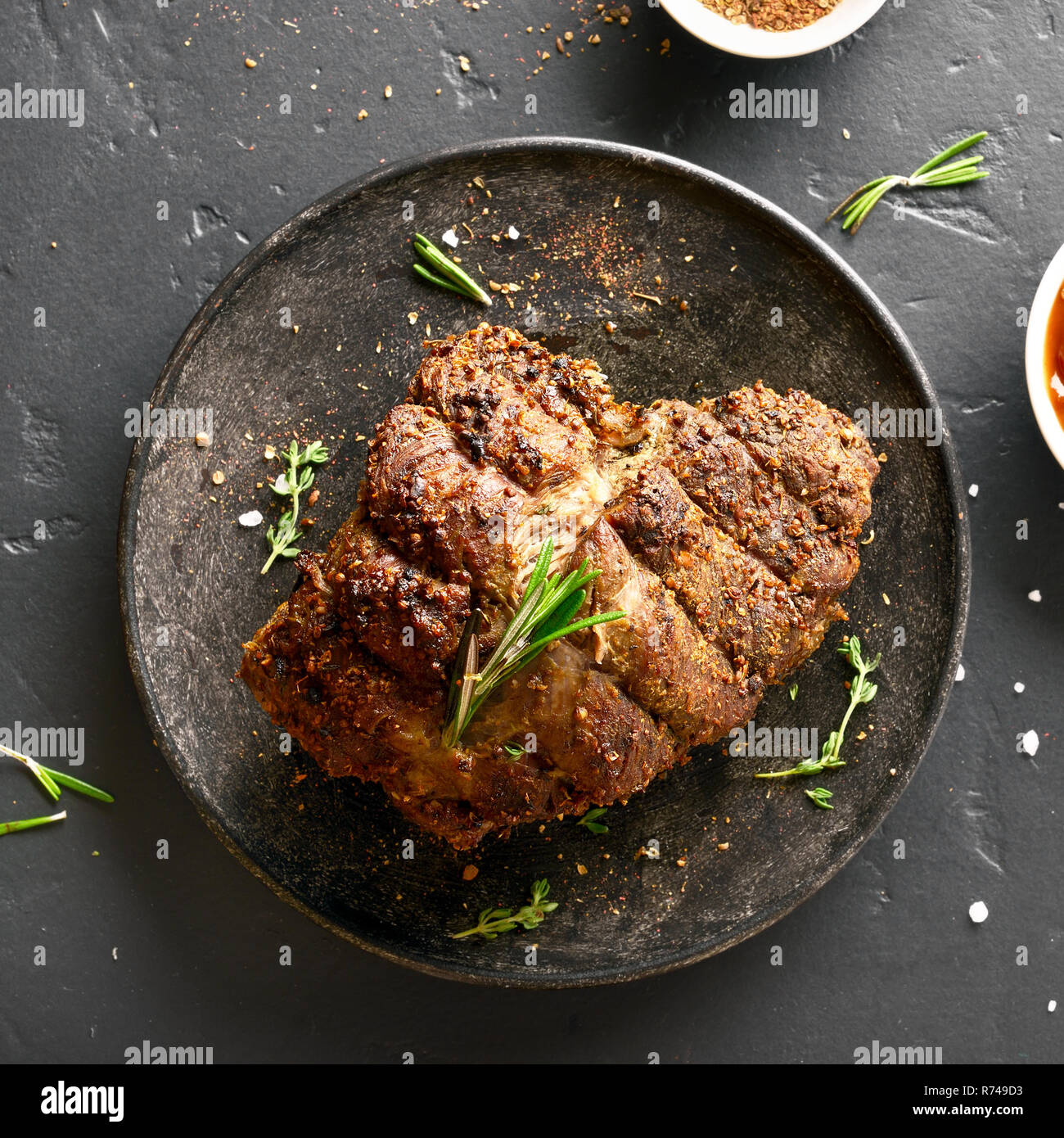Barbecue meat. Grilled beef on plate over black stone background. Top ...
