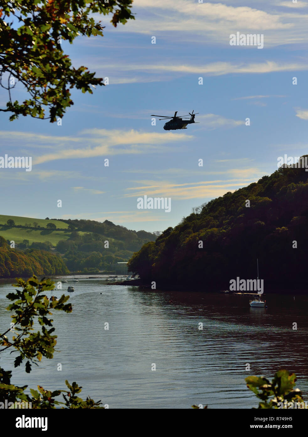 A helicopter flying over the river Dart near Dartmouth Stock Photo - Alamy