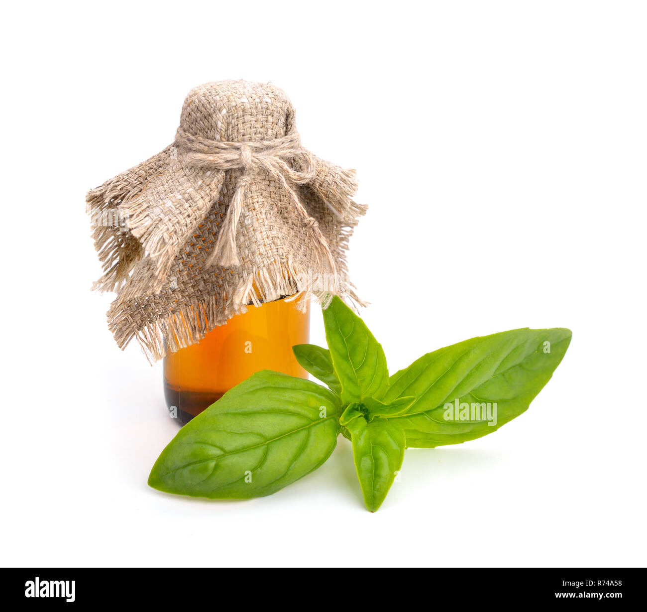 Essential oil of a basil isolated on white background Stock Photo - Alamy