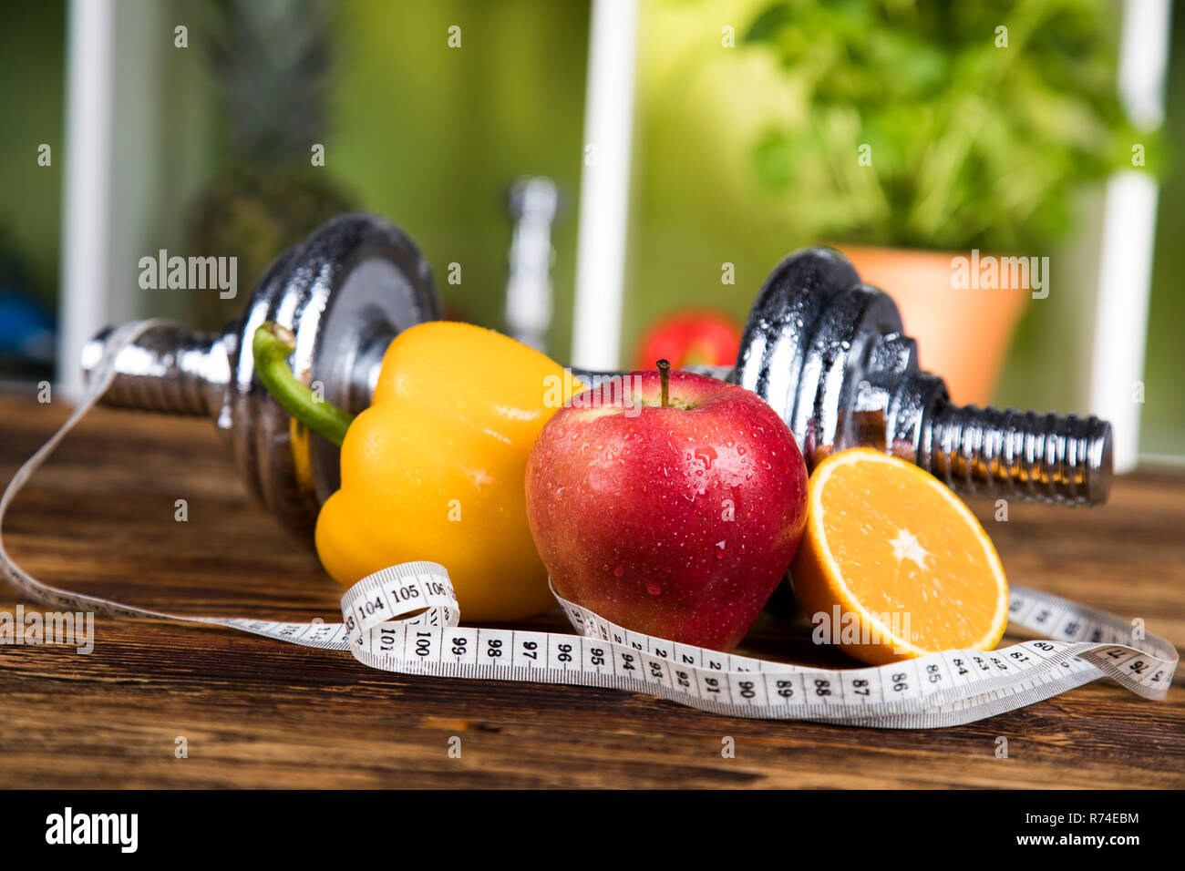 Fitness concept with dumbbells and fresh fruits Stock Photo - Alamy