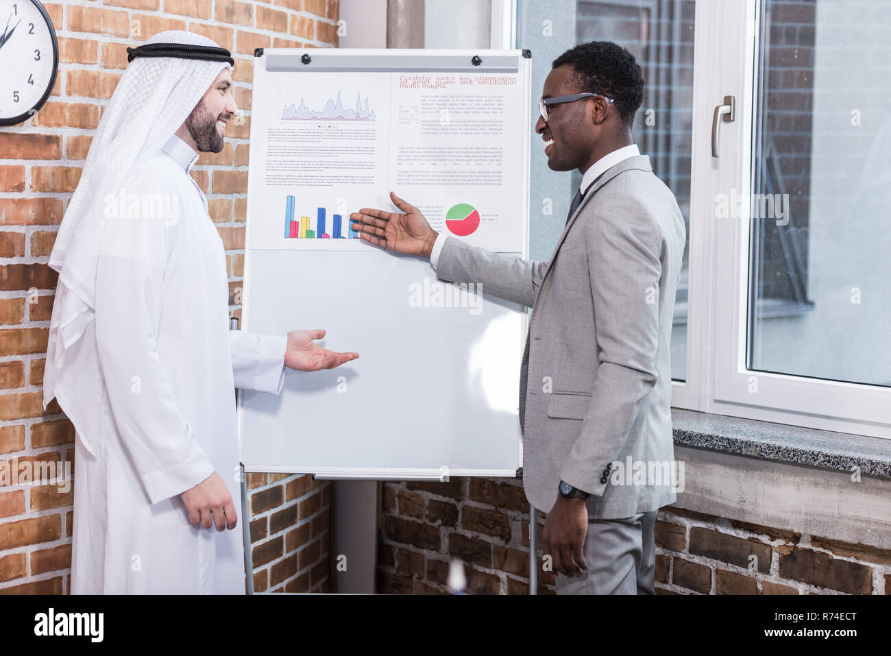African american businessman showing charts and graphs on whiteboard ...
