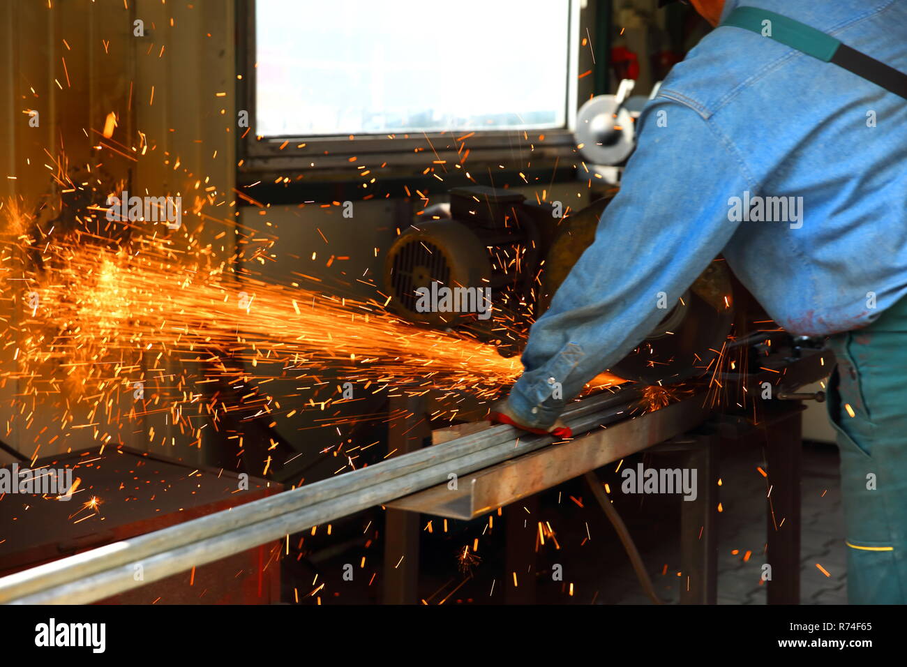 Cutting steel with a stationary large grinder Stock Photo - Alamy