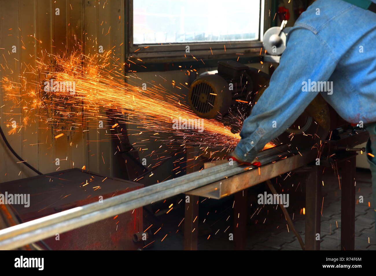 Cutting steel with a stationary large grinder Stock Photo - Alamy