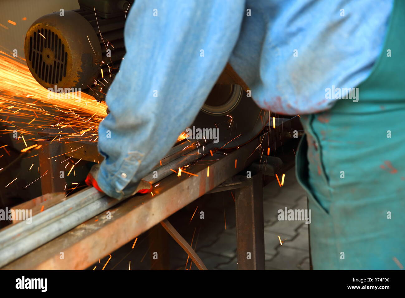 Cutting steel with a stationary large grinder Stock Photo - Alamy