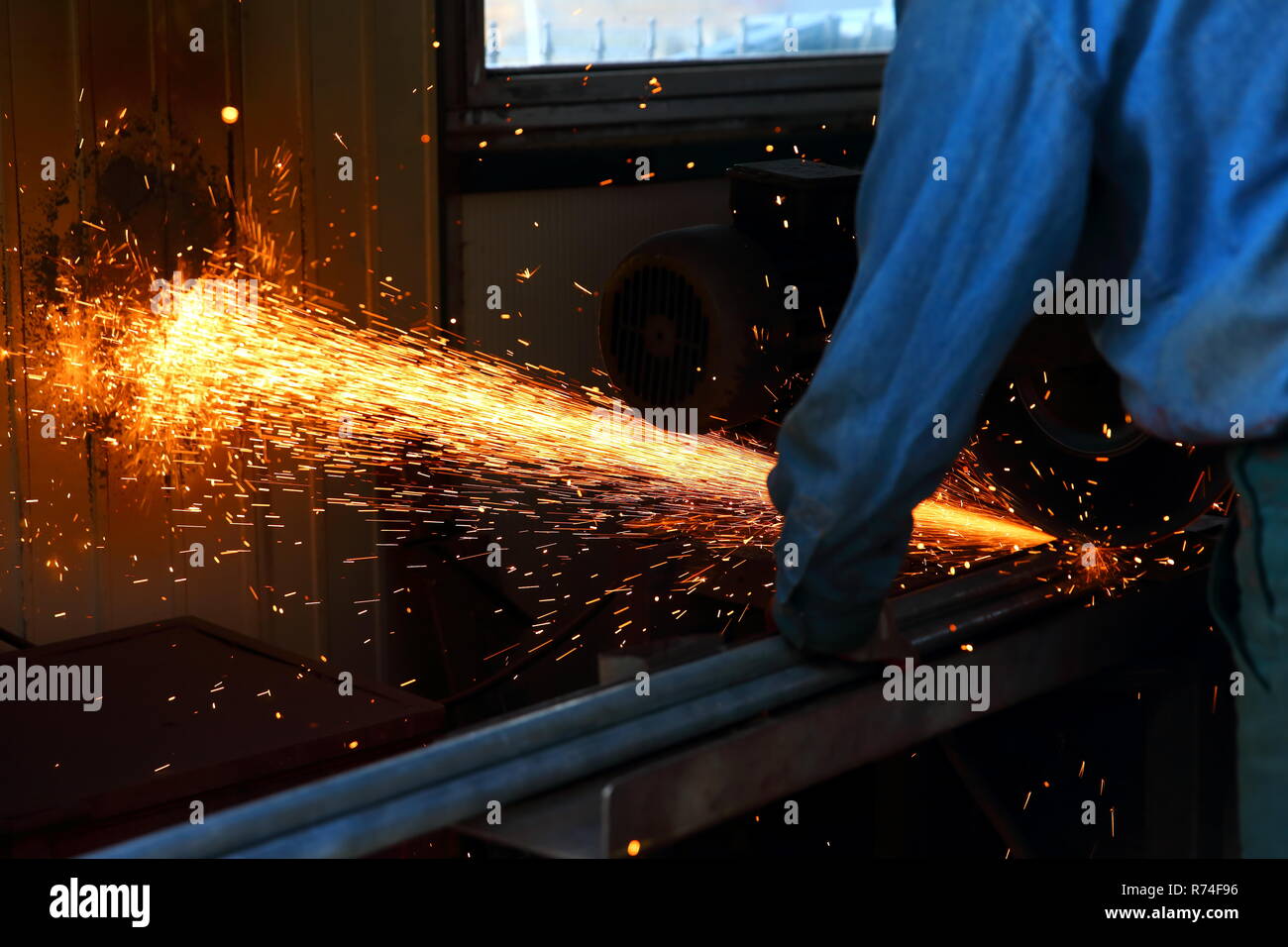 Cutting steel with a stationary large grinder Stock Photo - Alamy