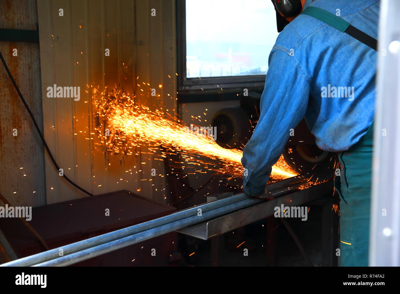 Cutting steel with a stationary large grinder Stock Photo - Alamy