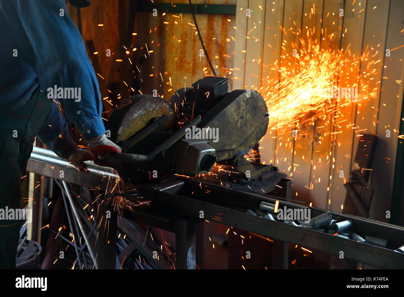 Cutting steel with a stationary large grinder Stock Photo - Alamy
