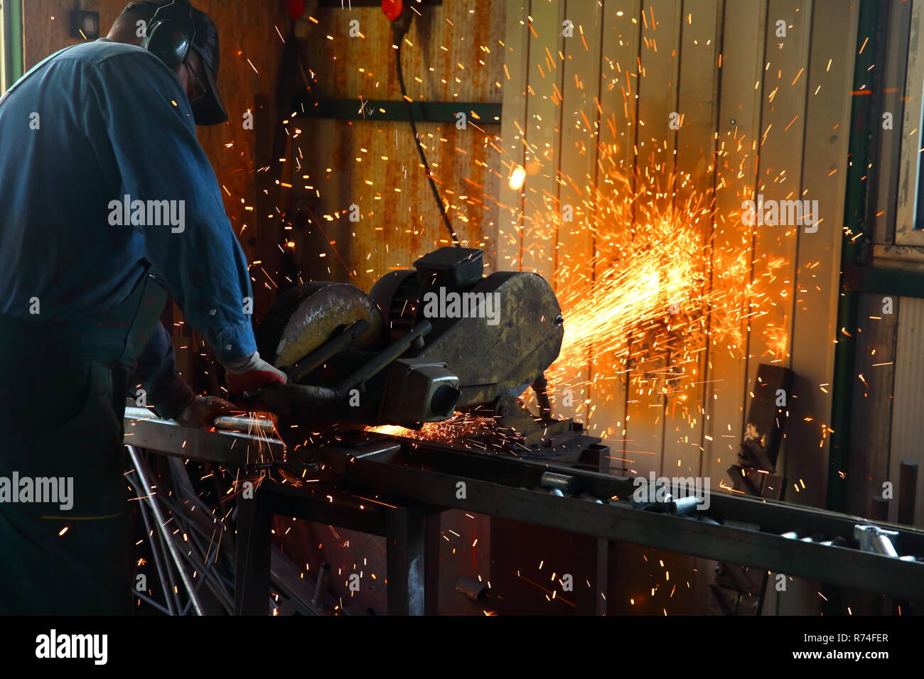 Cutting steel with a stationary large grinder Stock Photo - Alamy