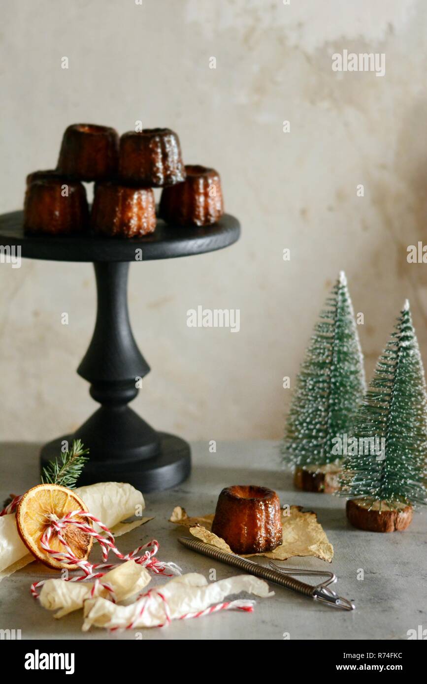 Traditional French sweet dessert canele cakes on the holiday table ...