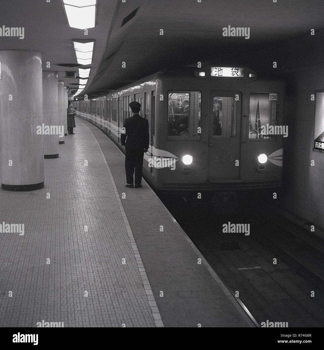 1960s, historical, a railway guard on a platform standing next to an ...